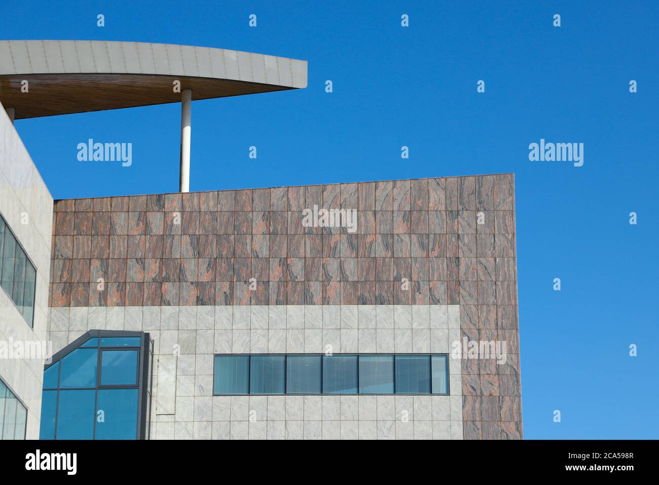 The top of a modern office building with polished stone exterior ...
