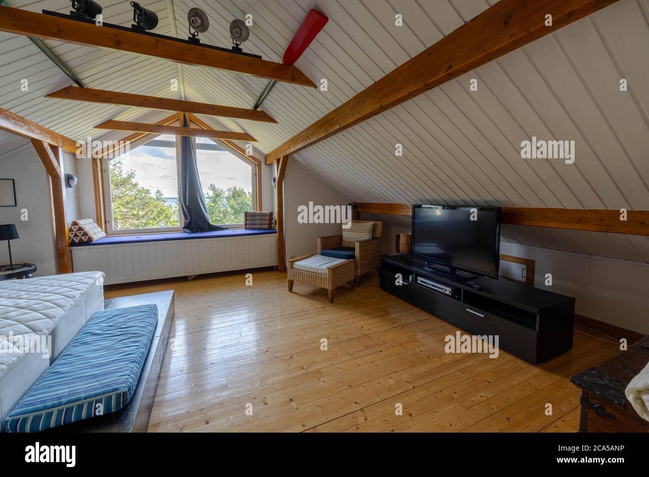 Beautiful interior view of upper floor room with big window and double ...