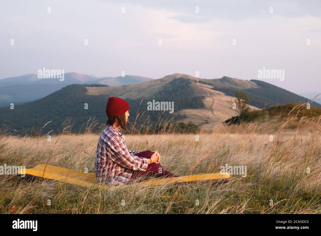 Alone girl in against the backdrop of an incredible autumn mountains ...