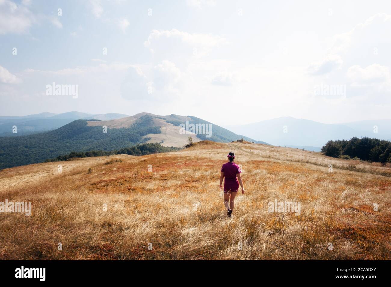 Alone girl in against the backdrop of an incredible autumn mountains ...