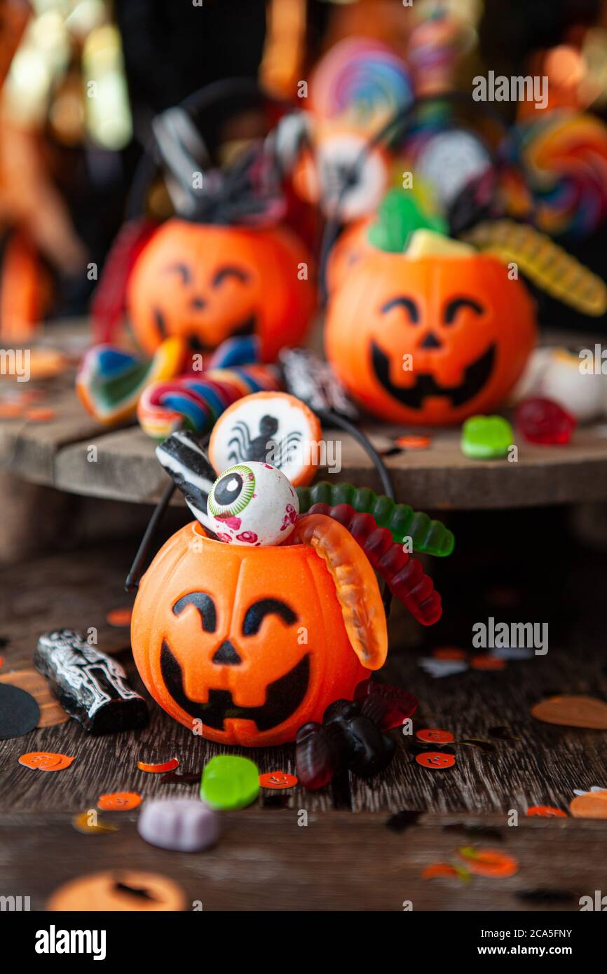 Colorful Halloween candy in little smiling pumpkin baskets Stock Photo ...