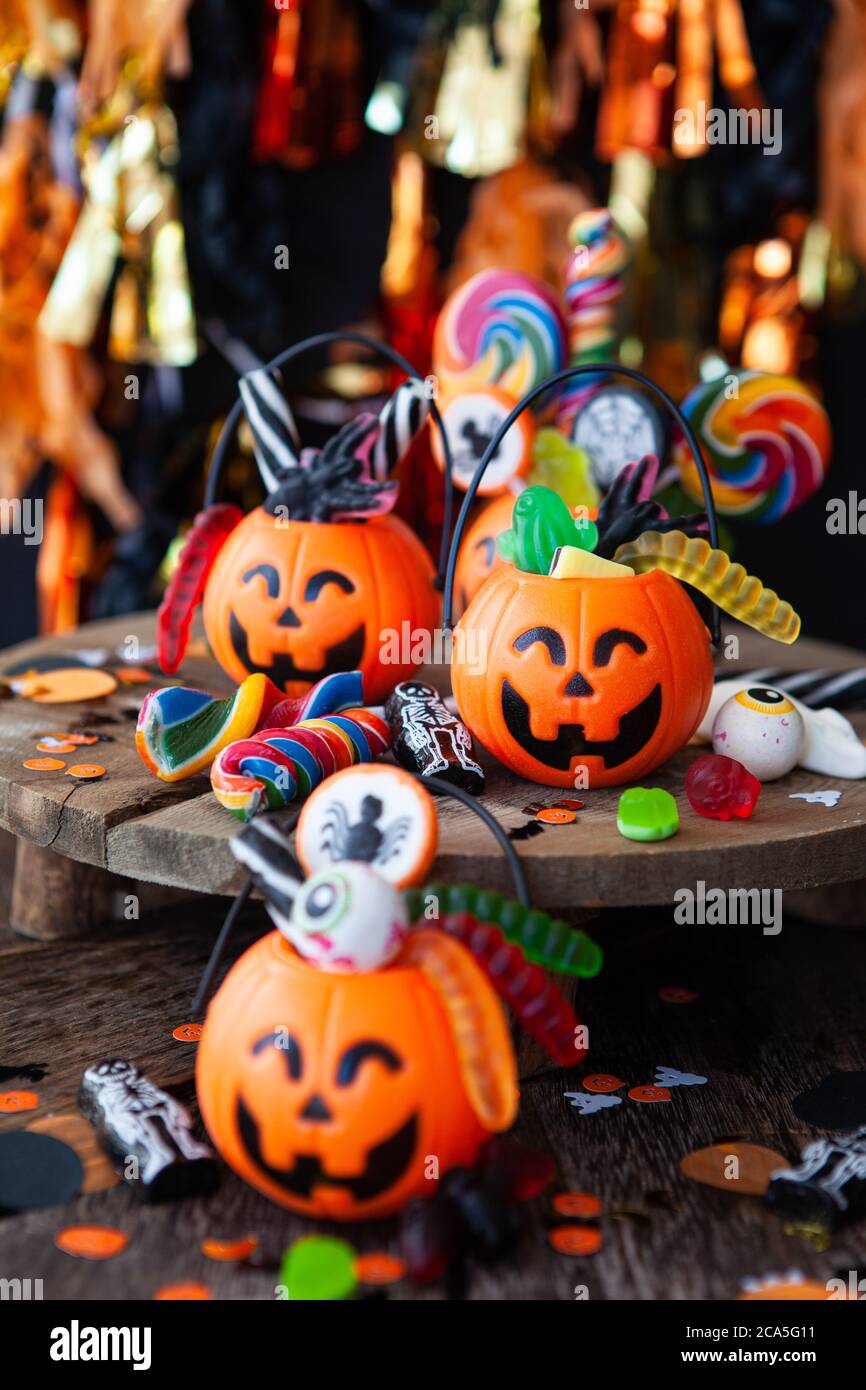 Colorful Halloween candy in little smiling pumpkin baskets Stock Photo ...