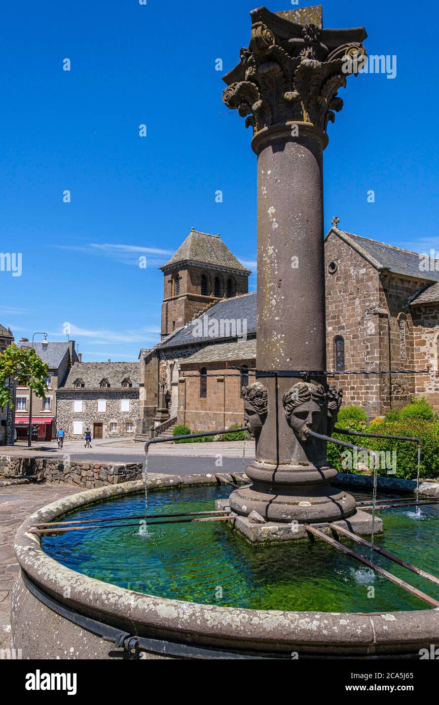 France, Cantal, fountain and church in the village of Trizac, regional ...