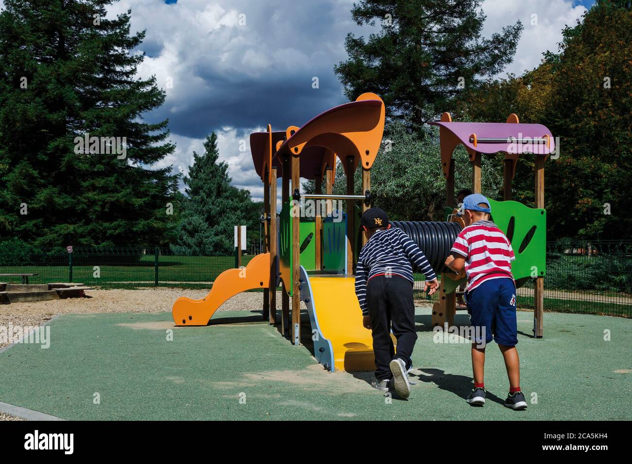 France, Yvelines, Les Mureaux, children playing on a playground in a ...