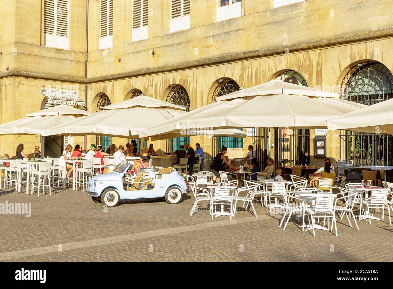 France, Moselle, Metz, terrace of a cafe and facade of the covered ...