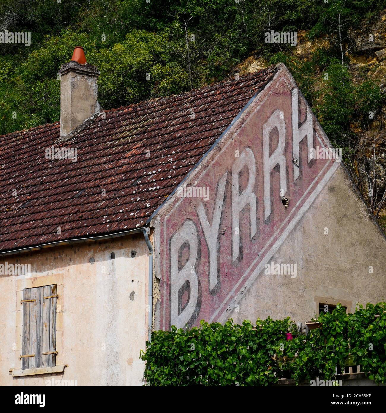 Old advert for French aperitive Byrrh, painted on a house side, Hamlet ...