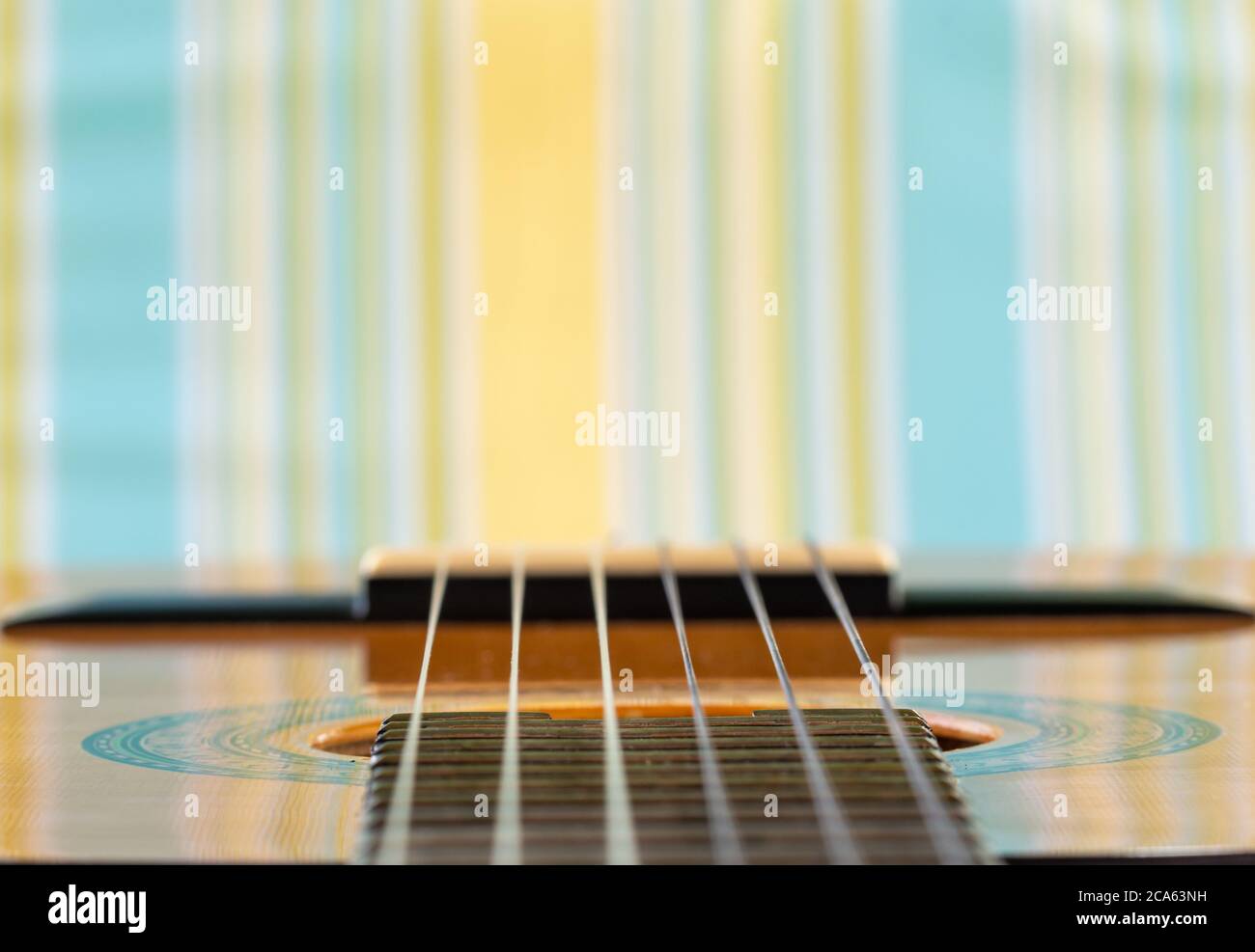 Perspective closeup of the strings of a guitar moving towards a ...