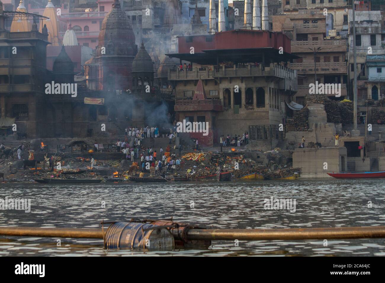 Cremation of bodies, on the burning ghat, on the banks of Ganges river ...
