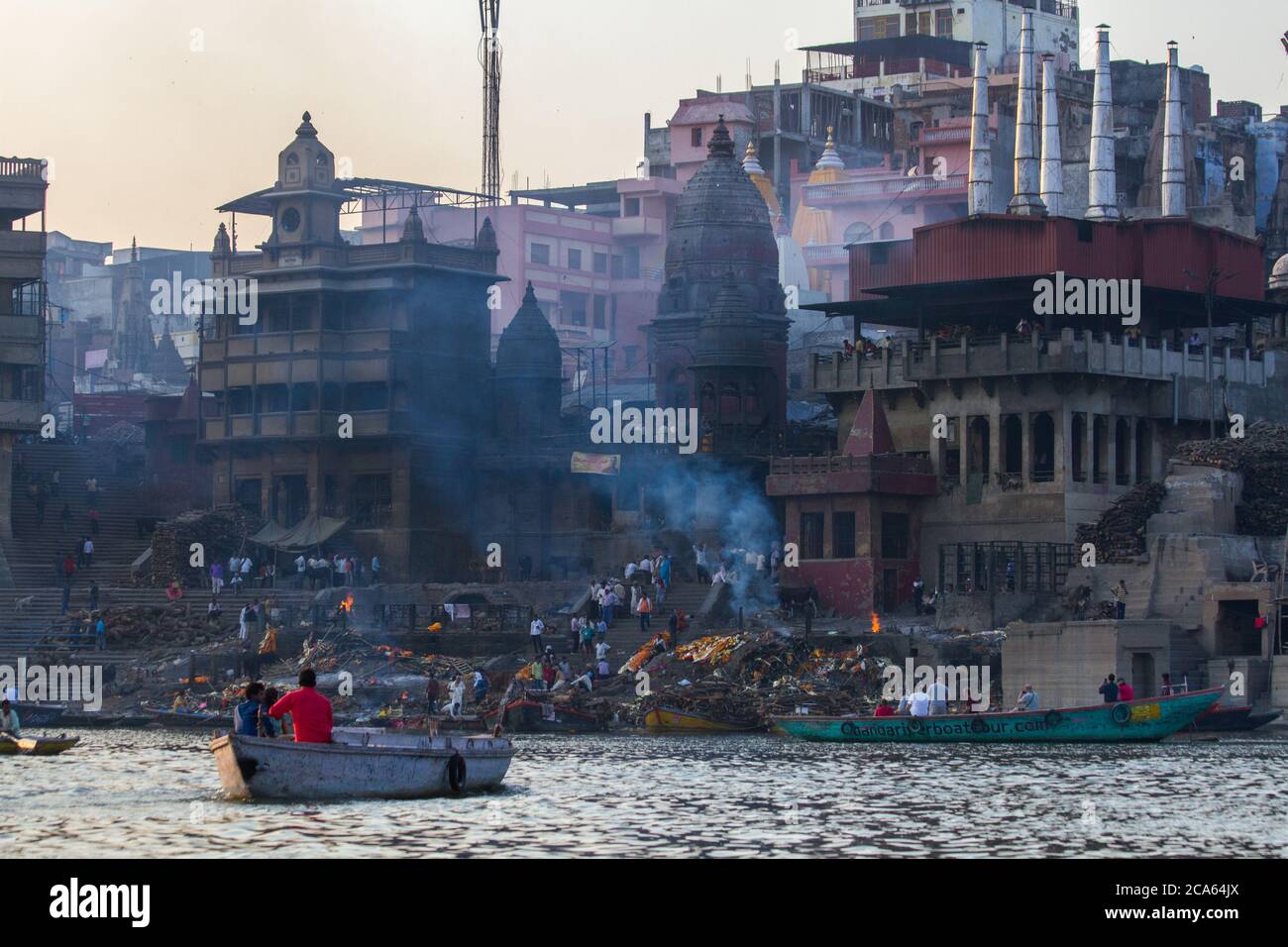 Cremation of bodies, on the burning ghat, on the banks of Ganges river ...