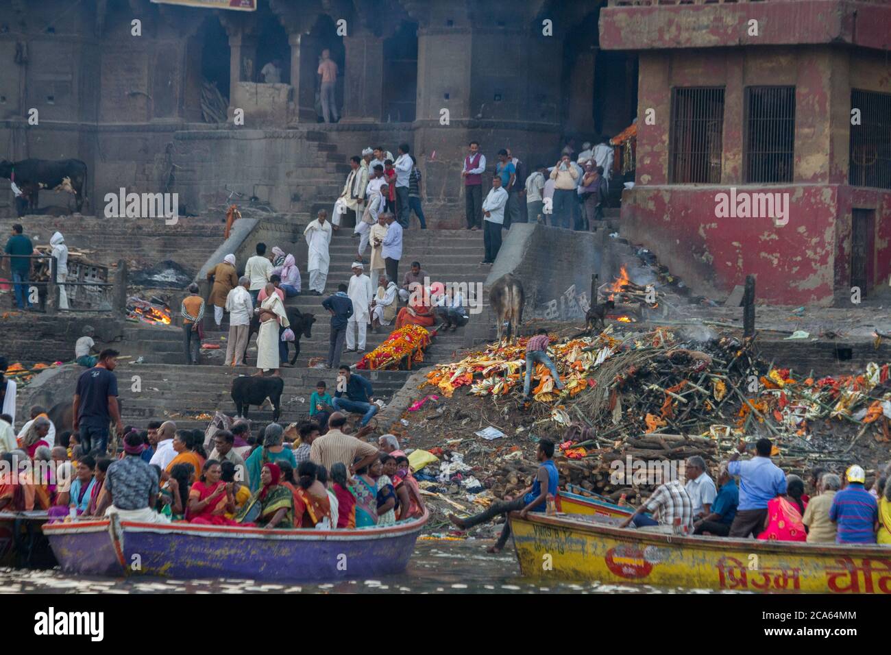 Cremation of bodies, on the burning ghat, on the banks of Ganges river ...