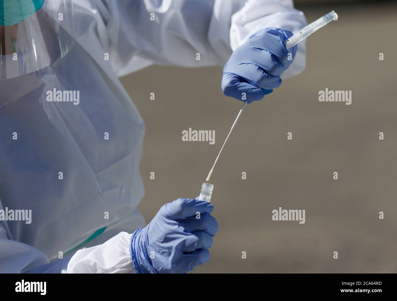 Dr. Beth Prinz puts a test in a tube after testing a patient in their ...
