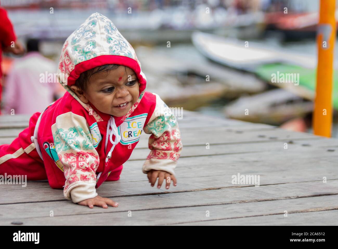 kid on a ghat close to the ganges river, Varanasi, Uttar Pradesh, India ...