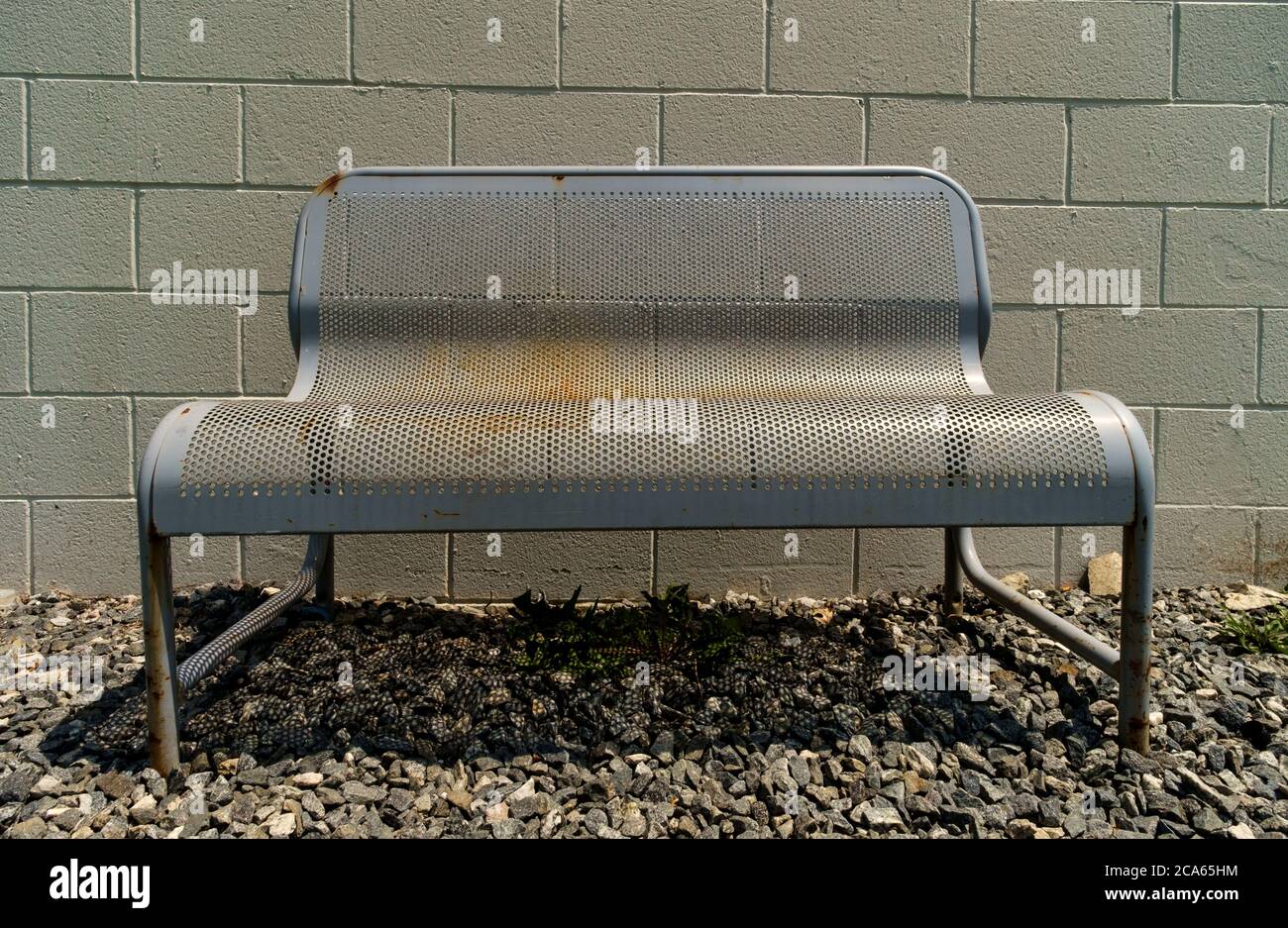 Worn metal bench with brick wall background with nobody Stock Photo - Alamy