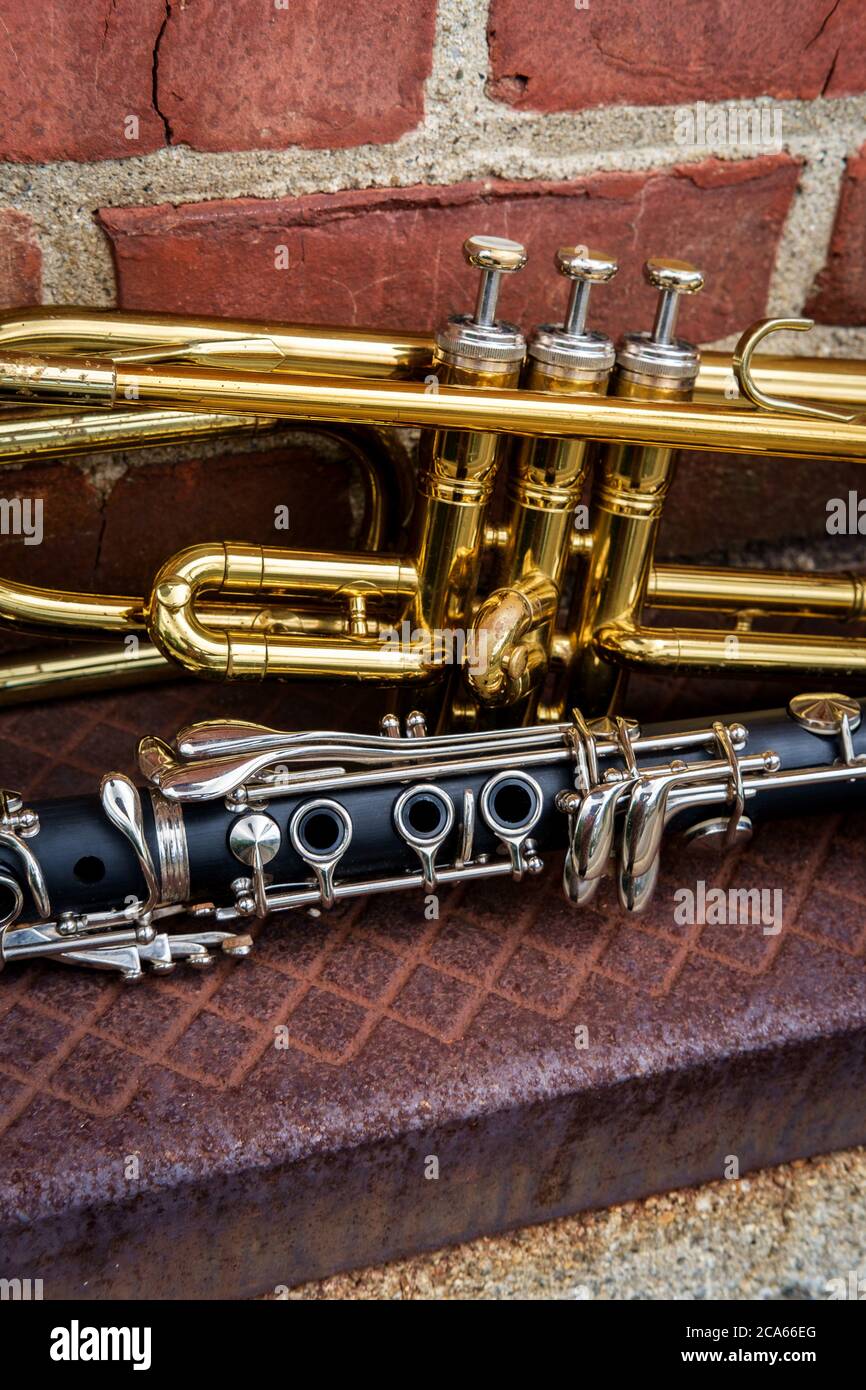 Musical instruments including trumpet and clarinet on brick wall ...