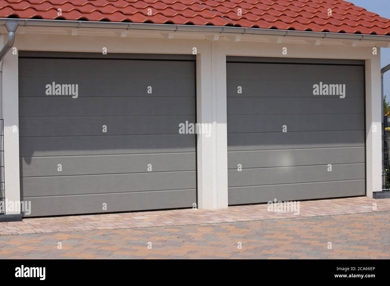 Two modern new garage doors (sectional doors Stock Photo - Alamy