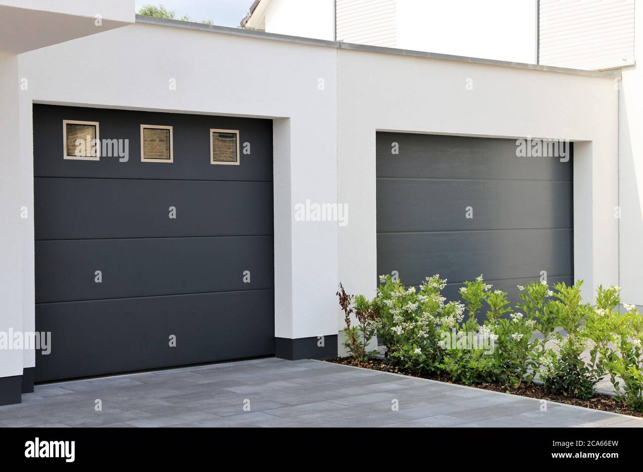 Two modern new garage doors (sectional doors Stock Photo - Alamy