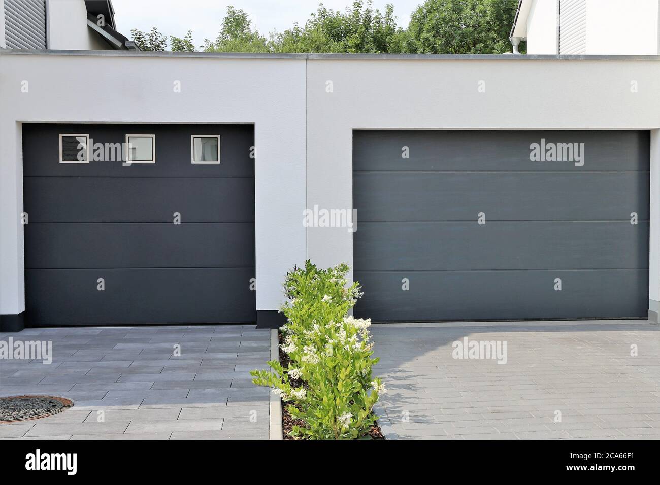 Two modern new garage doors (sectional doors Stock Photo - Alamy