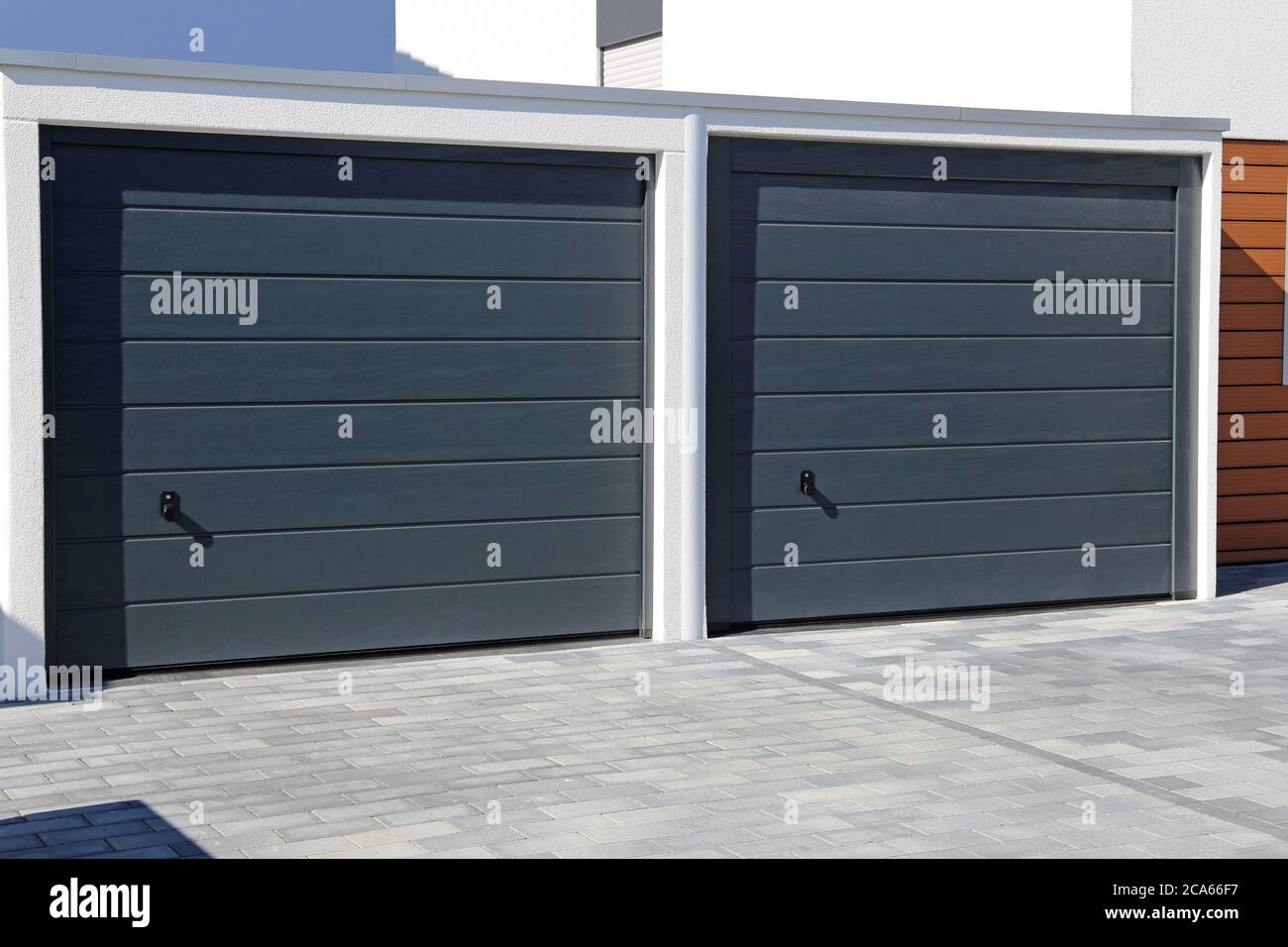 Two modern new garage doors (sectional doors Stock Photo - Alamy