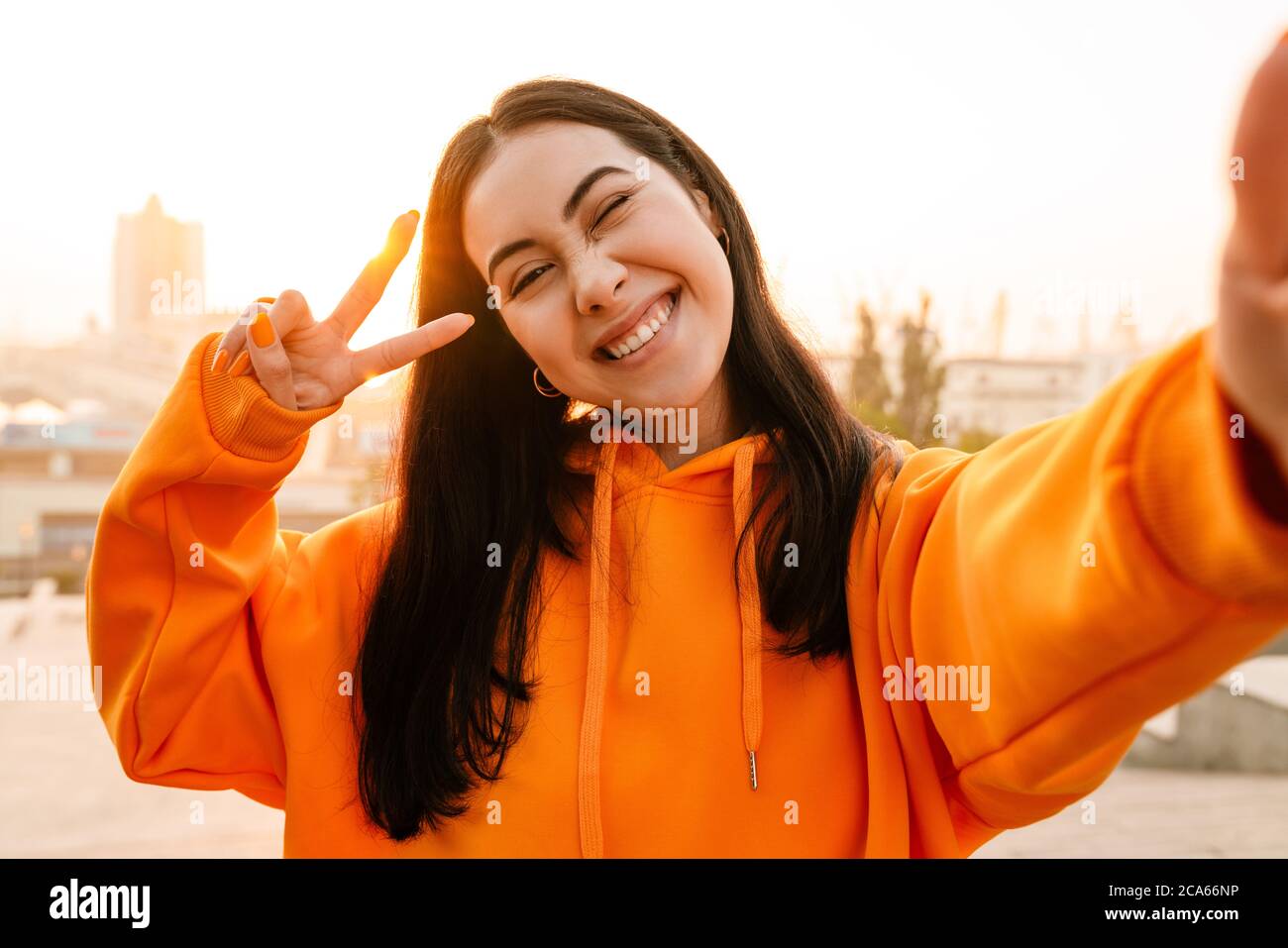 Asian woman gesturing peace sign hi-res stock photography and images - Alamy