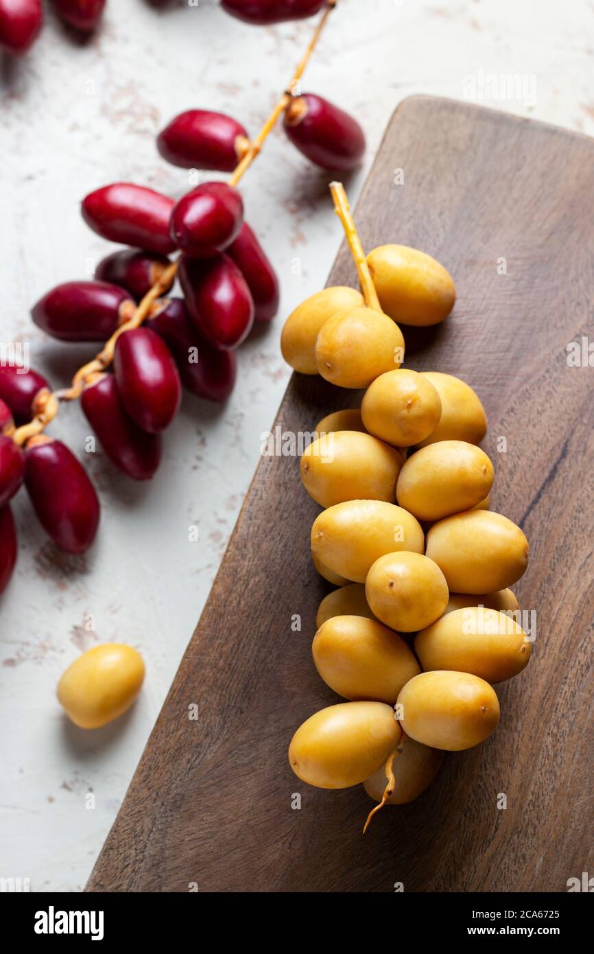 fresh yellow and red dates on wooden background Stock Photo - Alamy