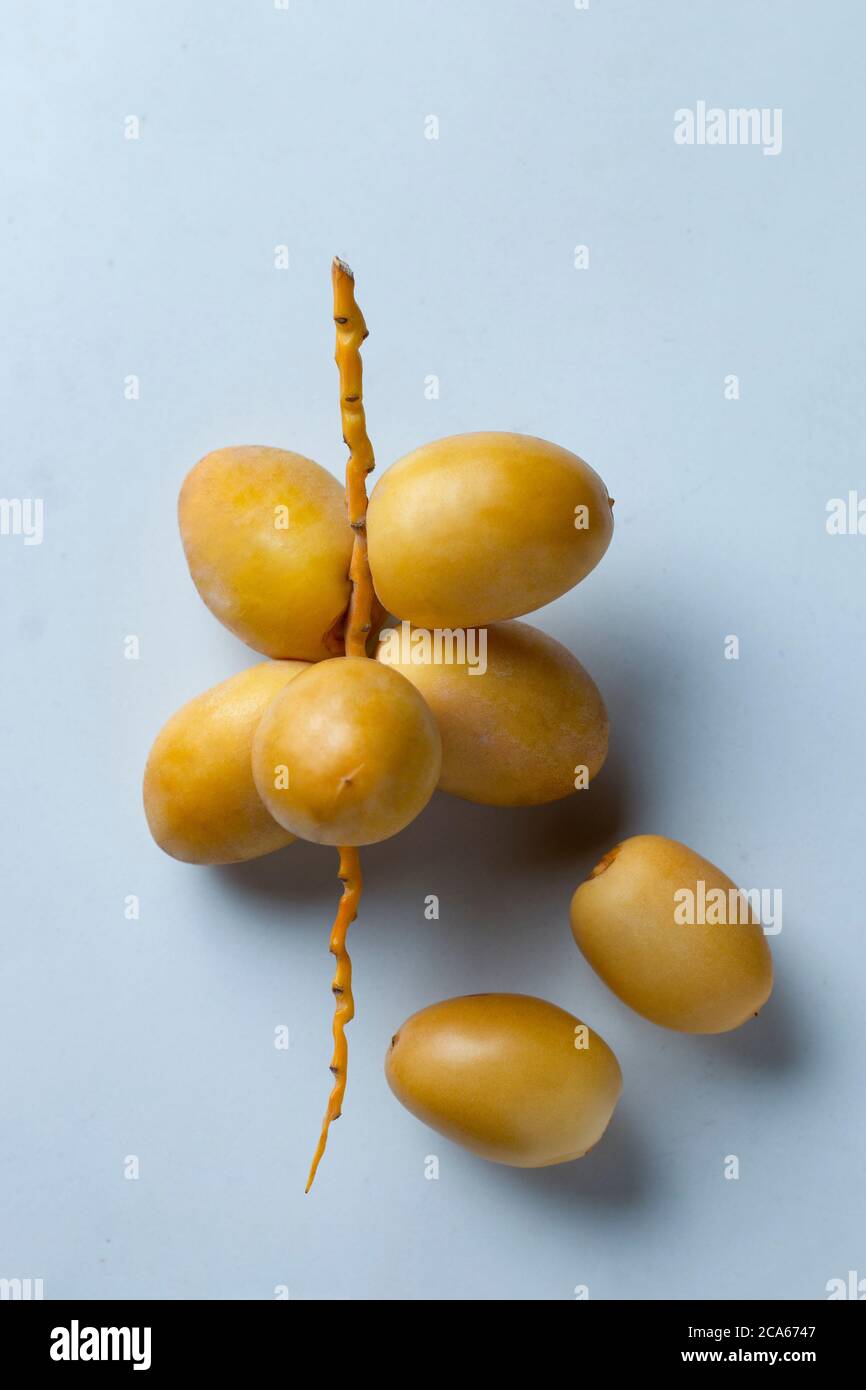 yellow fresh dates fruit isolate on white background Stock Photo - Alamy