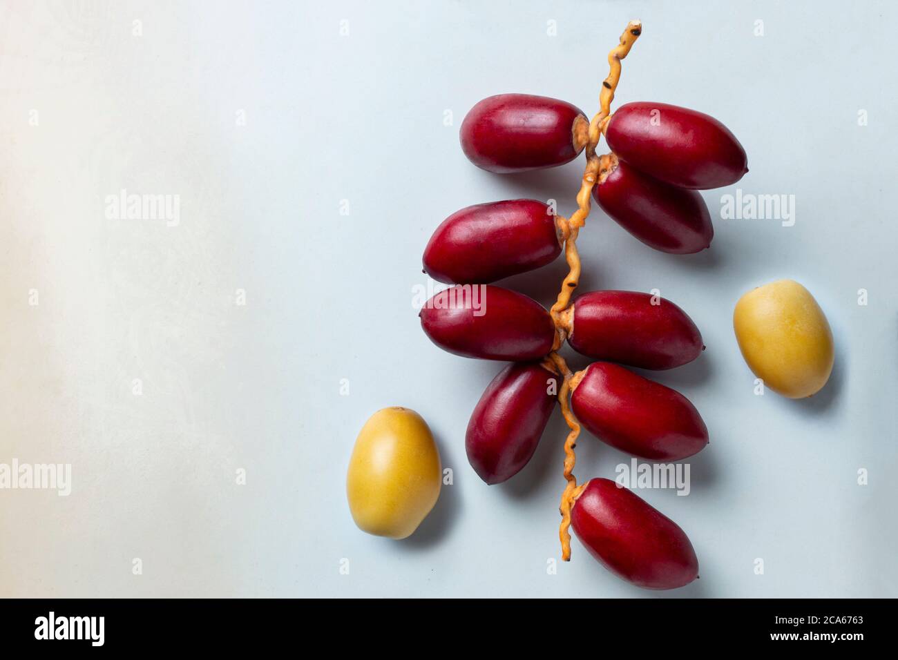 red dates fruit on white background Stock Photo - Alamy