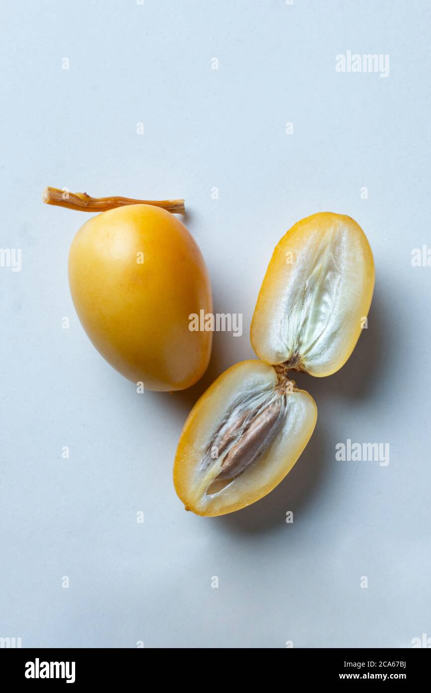 yellow fresh dates fruit isolate on white background Stock Photo - Alamy
