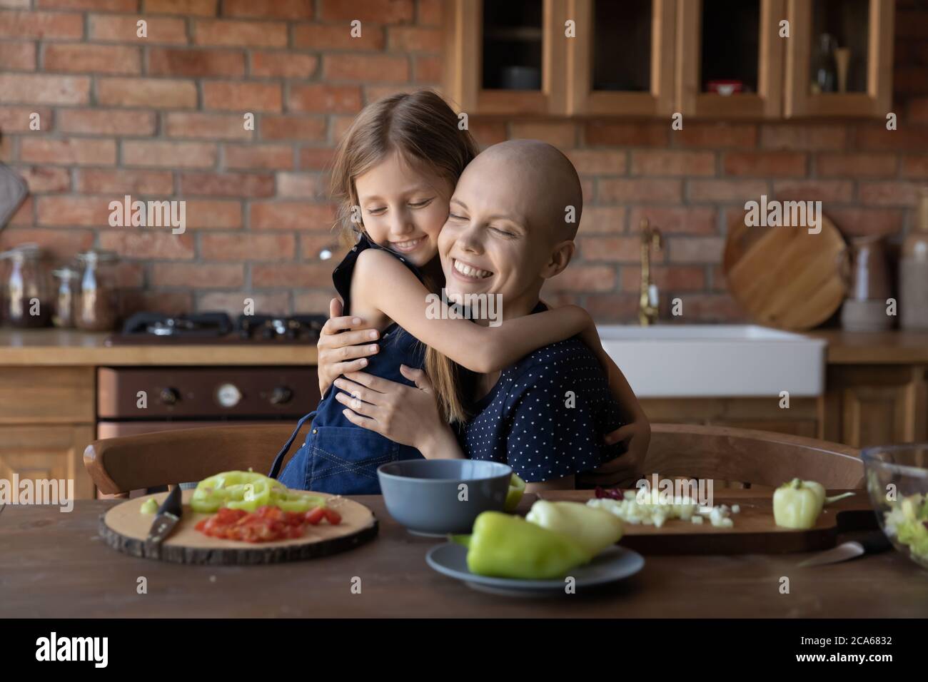 Loving little girl hug cancer sick young mom Stock Photo - Alamy