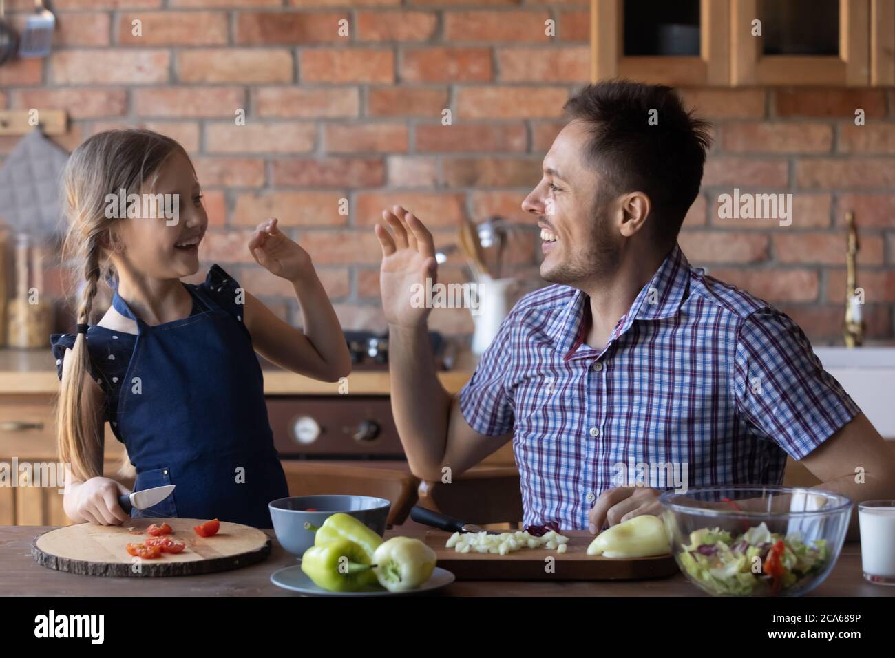 Excited young dad and daughter have fun cooking Stock Photo - Alamy