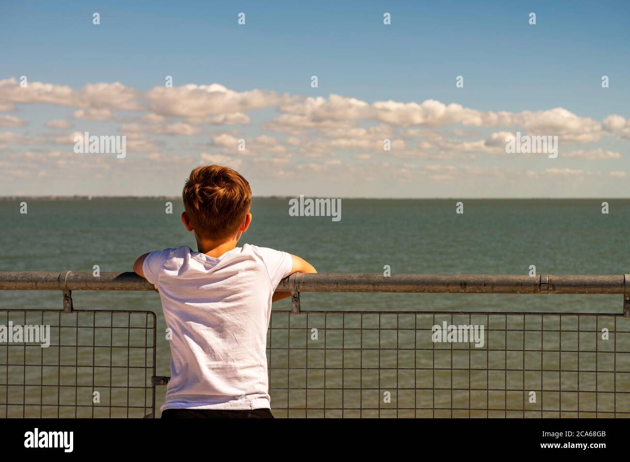 Boy looking behind rear view hi-res stock photography and images - Alamy