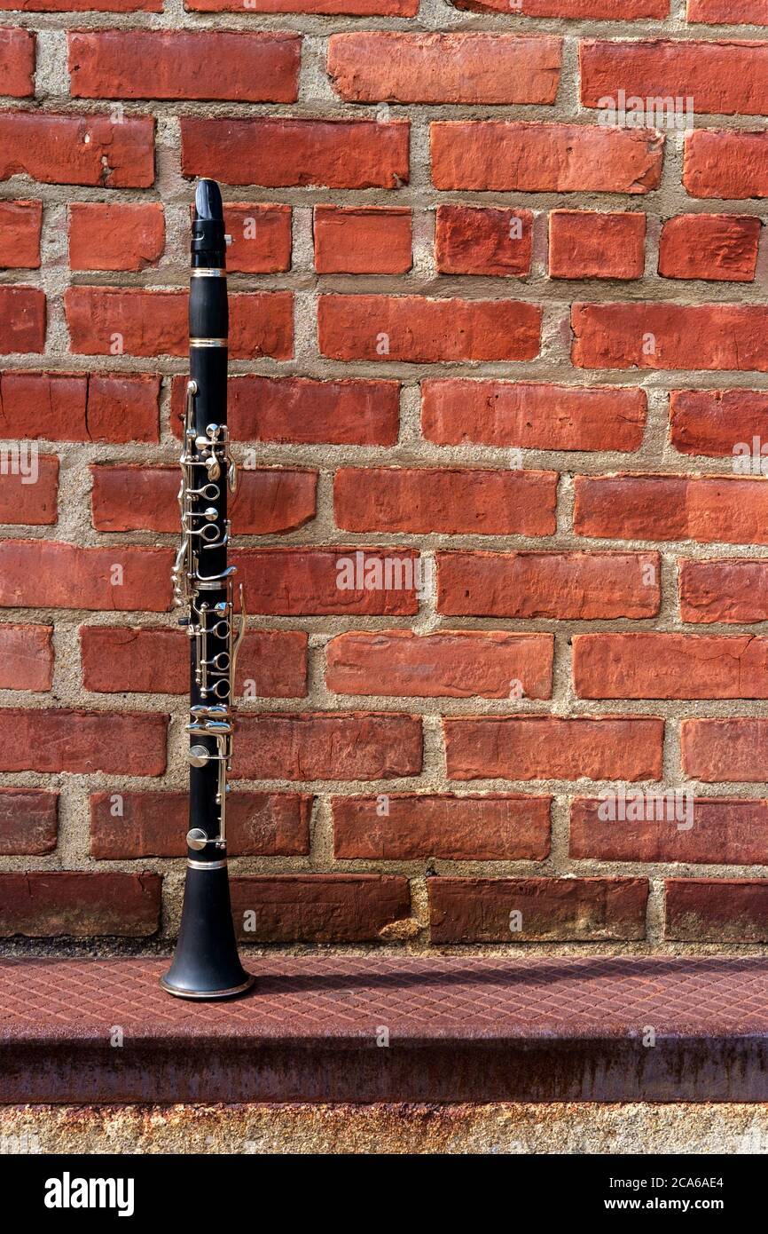 Clarinet abandoned by outdoor brick building after musical show or ...