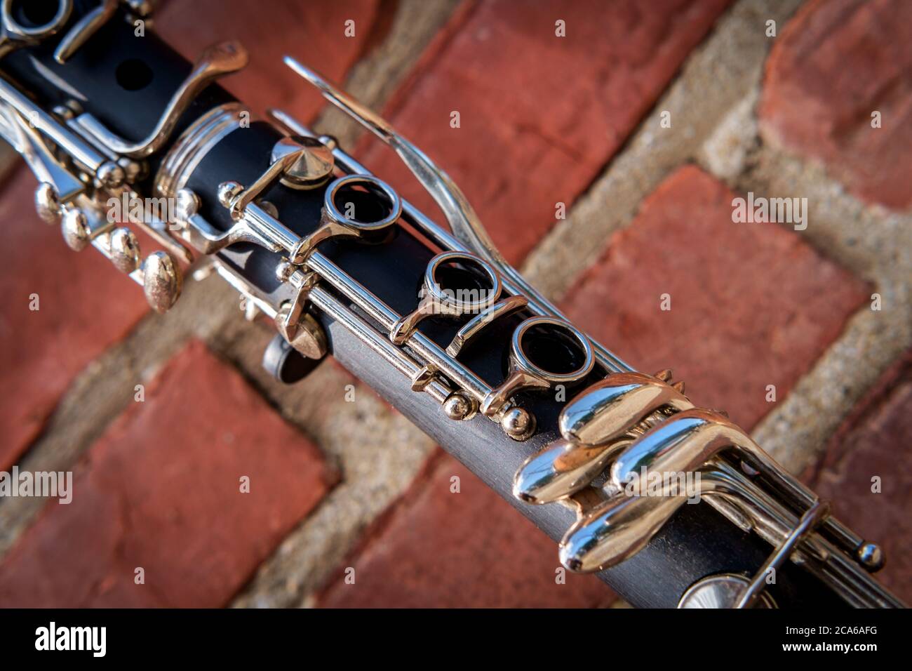 Clarinet abandoned by outdoor brick building after musical show or ...