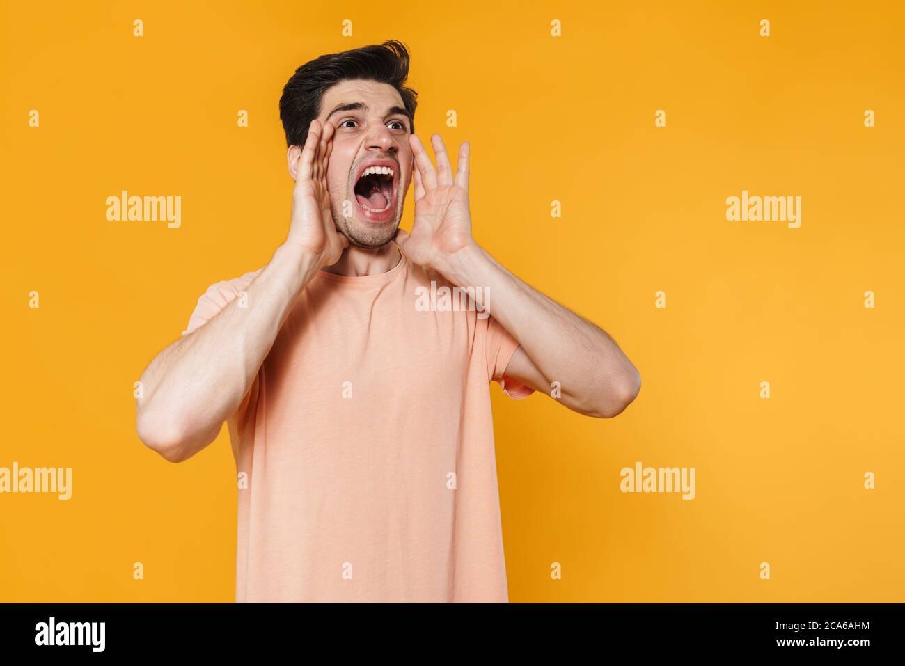 Photo of furious handsome man screaming with throwing up hands isolated ...