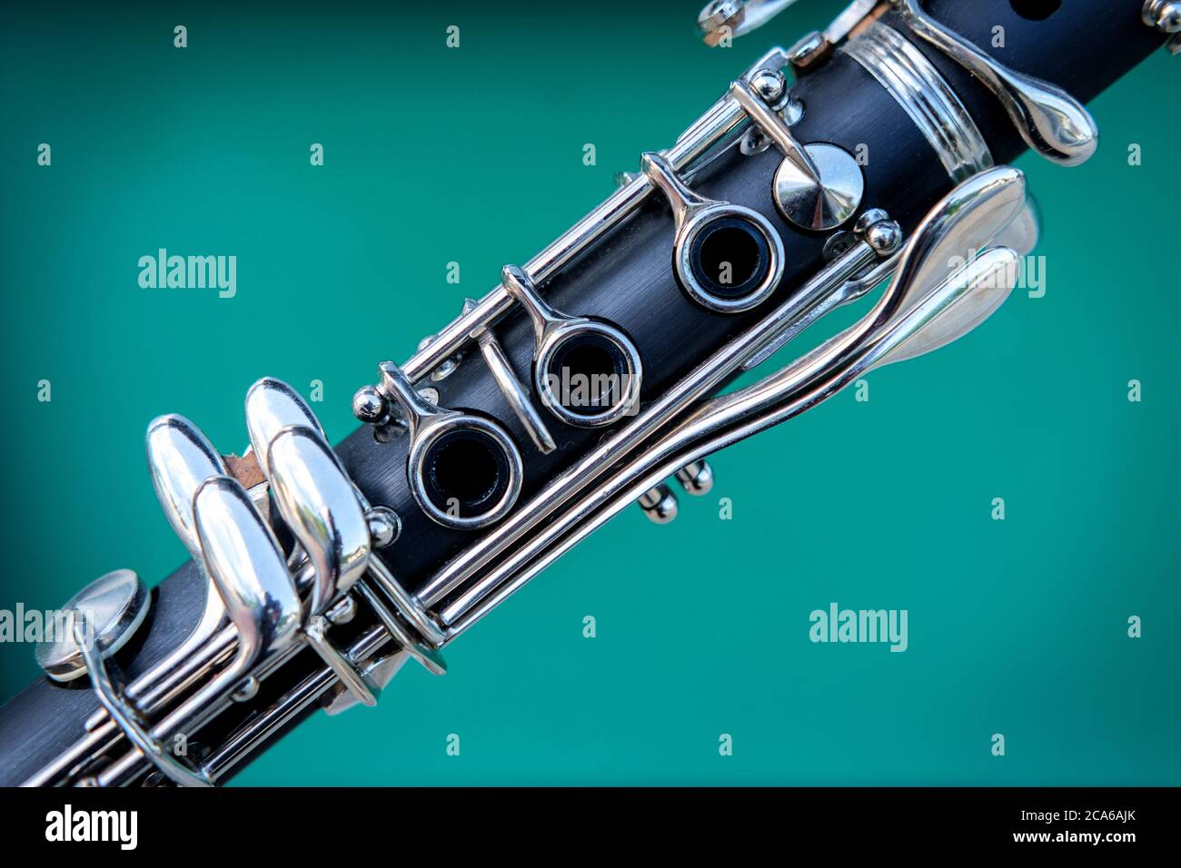 Classical clarinet keys in closeup with green background Stock Photo ...