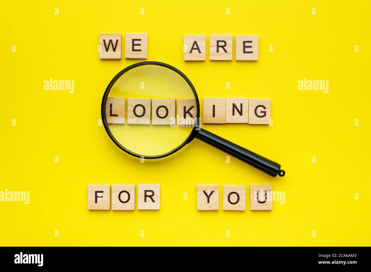 wooden block lettering we are looking for you and magnifying glass ...