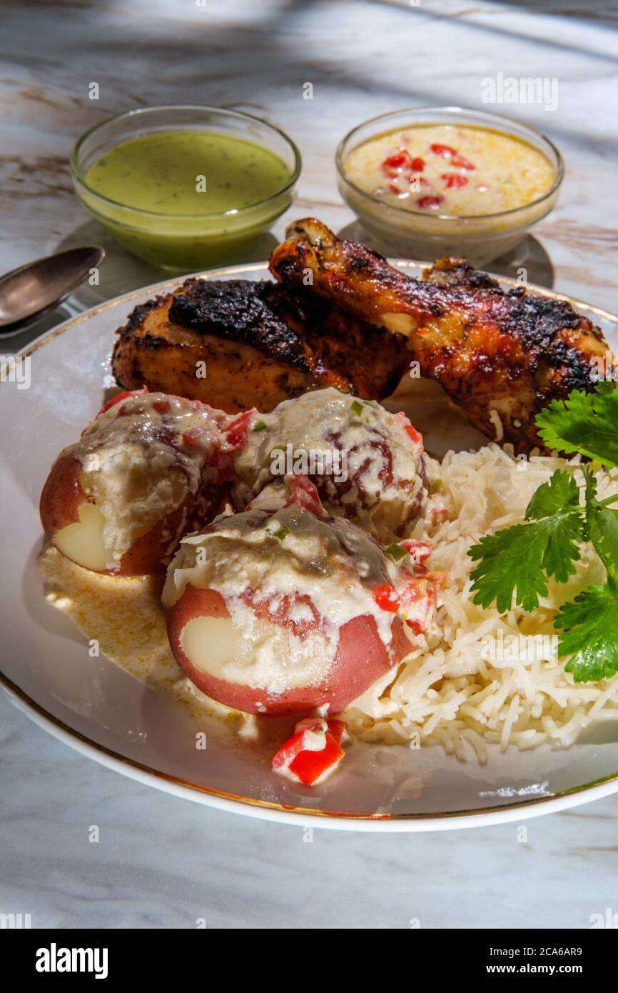 Colombian cuisine papas chorreadas roasted chicken legs and rice Stock ...