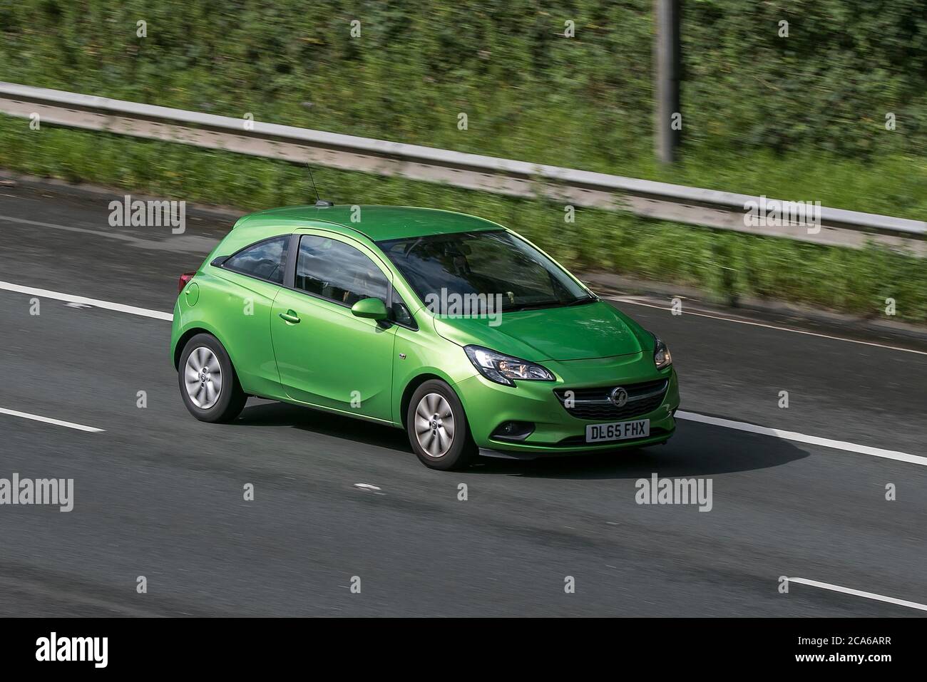 A 2015 Vauxhall Corsa Design Green Car Hatchback Petrol driving on the ...
