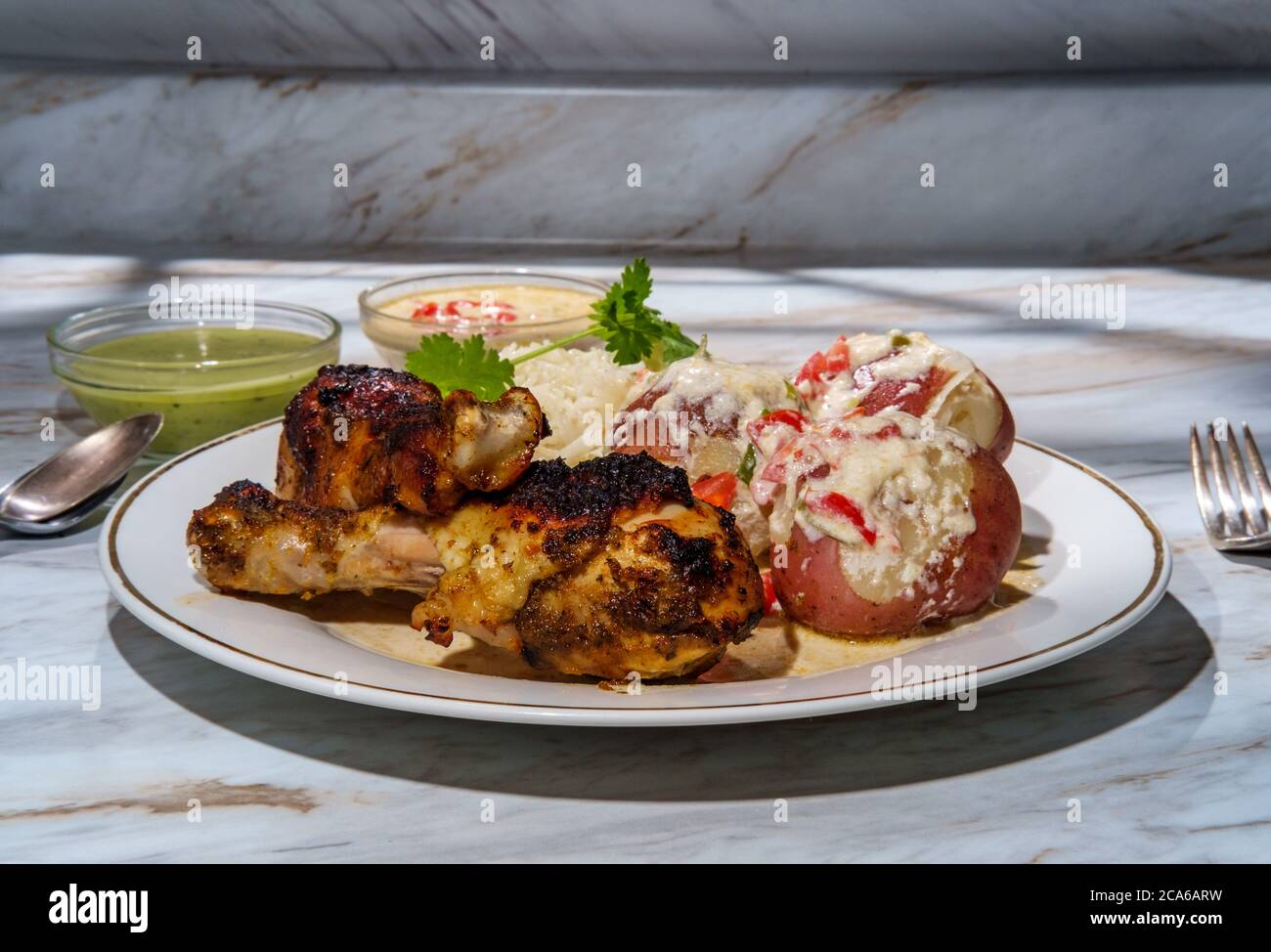 Colombian cuisine papas chorreadas roasted chicken legs and rice Stock ...