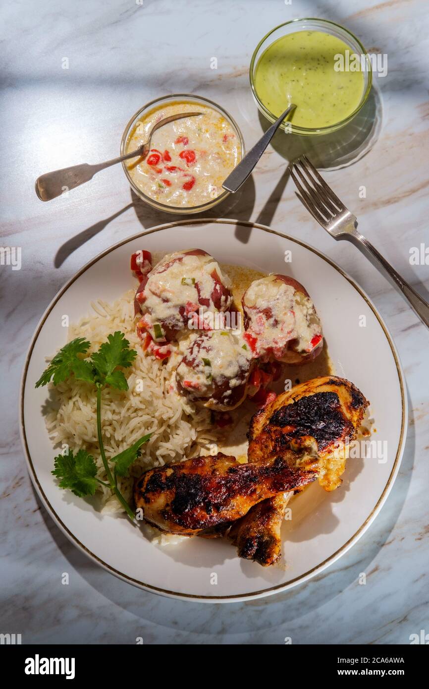 Colombian cuisine papas chorreadas roasted chicken legs and rice Stock ...