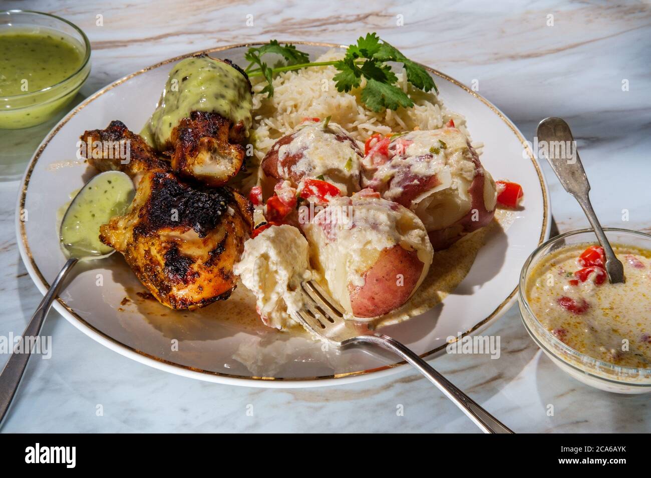 Colombian cuisine papas chorreadas roasted chicken legs and rice Stock ...
