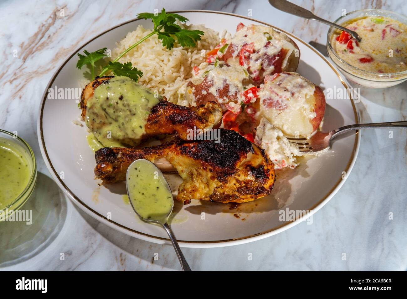 Colombian cuisine papas chorreadas roasted chicken legs and rice Stock ...