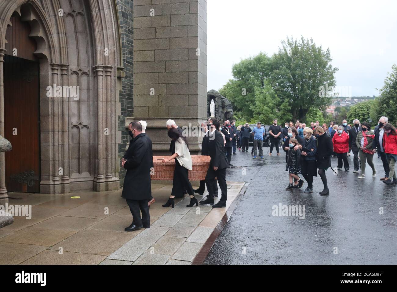 Family members form a guard of honour as the coffin of John Hume is ...