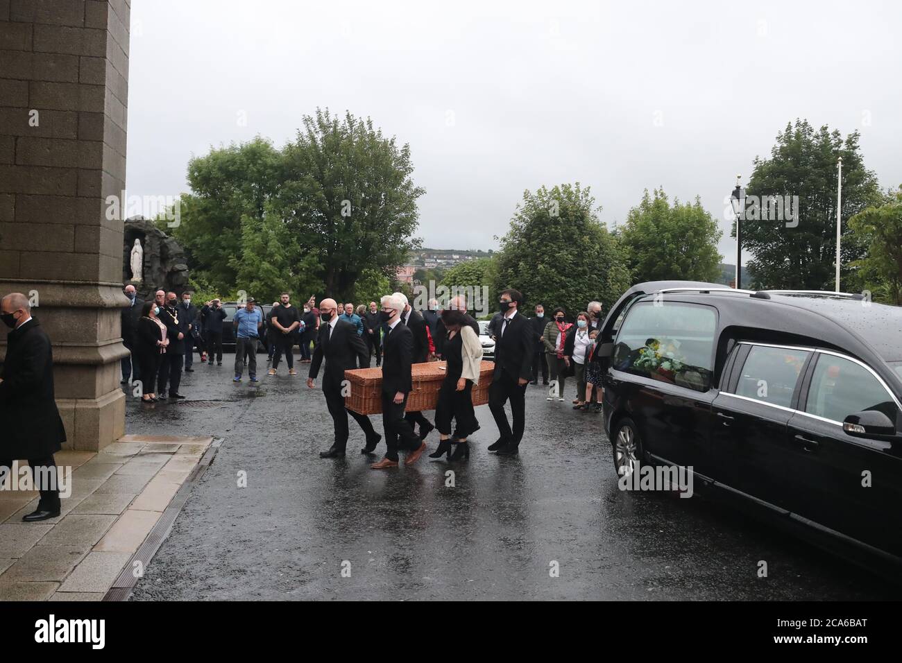 Family members form a guard of honour as the coffin of John Hume is ...