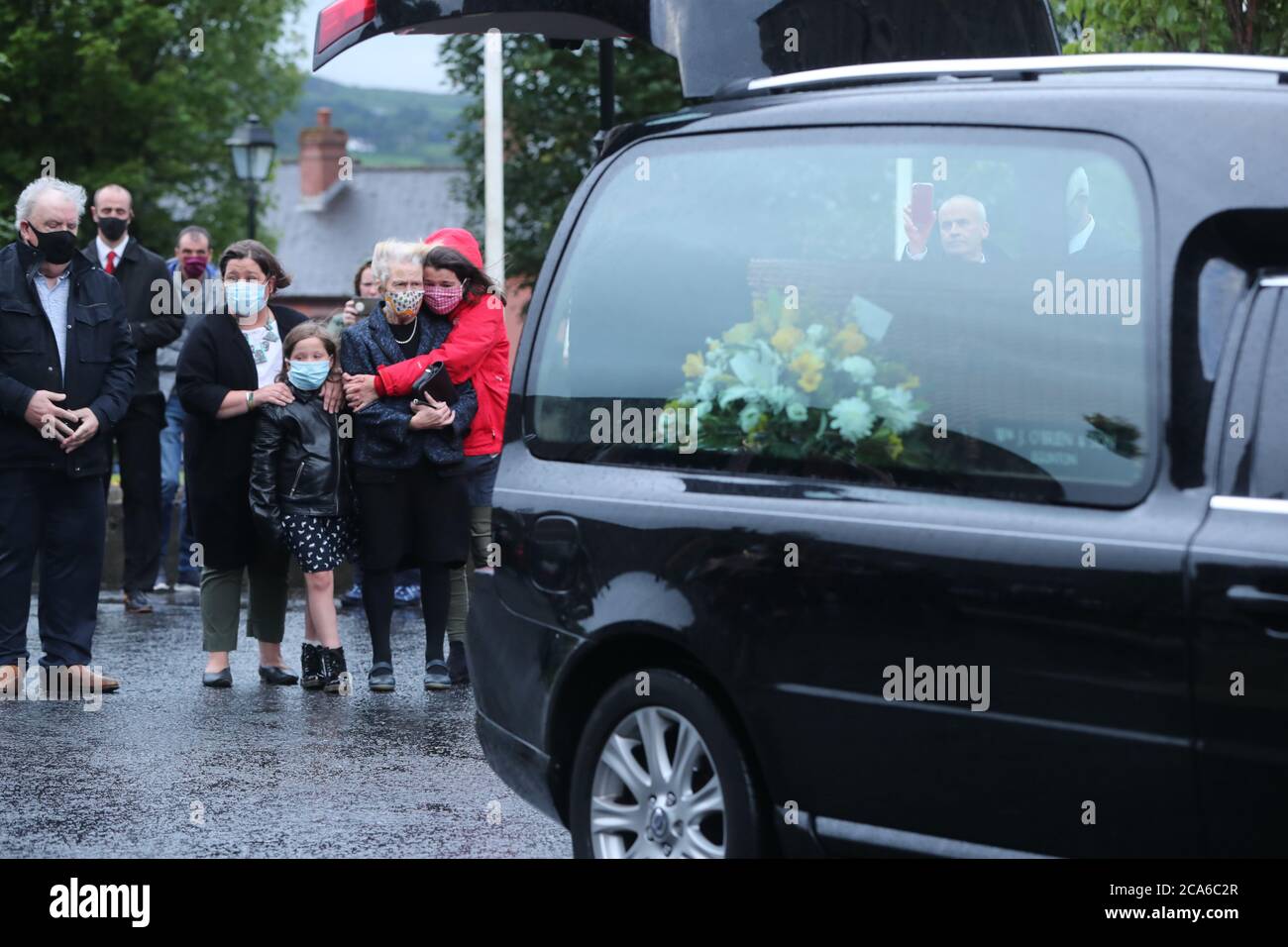 Family members watch as the coffin of John Hume is taken into St Eugene ...
