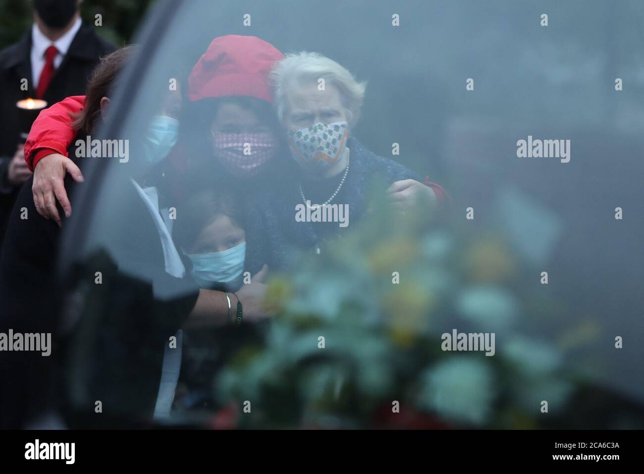 Family members watch as the coffin of John Hume is taken into St Eugene ...