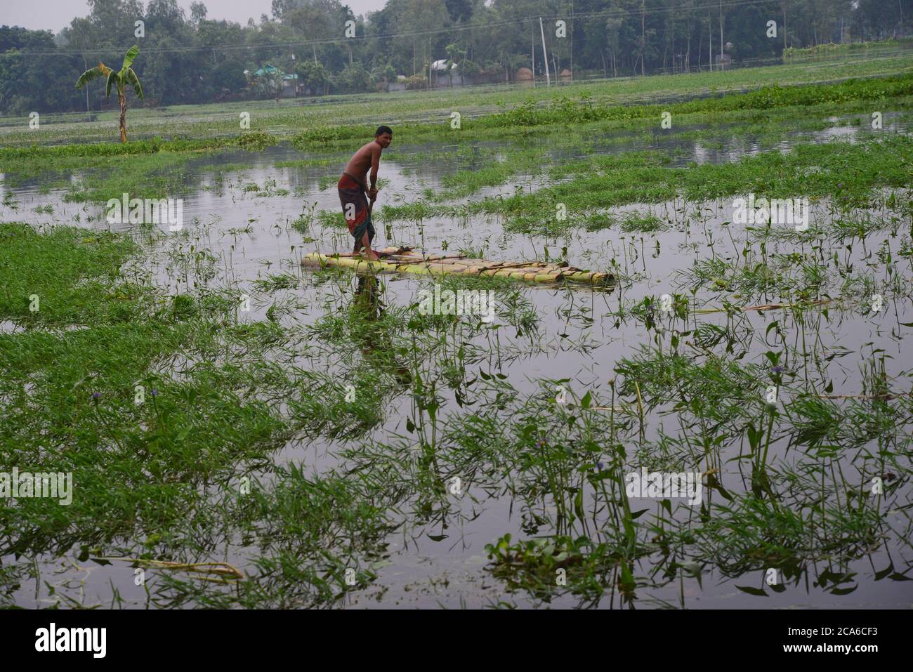Villagers ride on makeshift raft in the flood water in Jamalpur ...