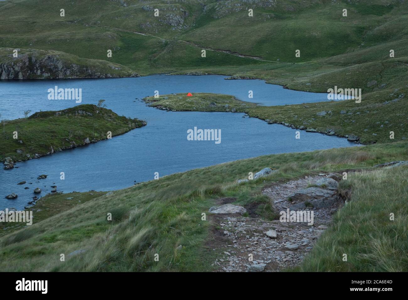 A tent pitched on the shore of Angle Tarn, in the English Lake District ...