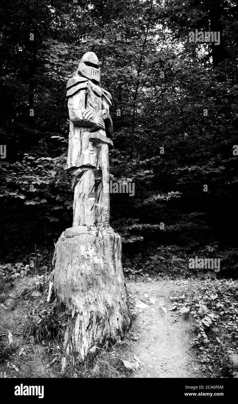 Wooden sculpture of a knight at the entrance to ruins of the medieval ...