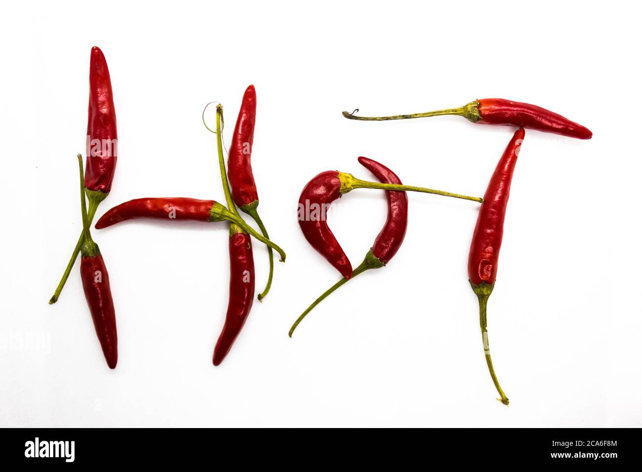 Red small chillies sticking together creating a word - Hot representing ...