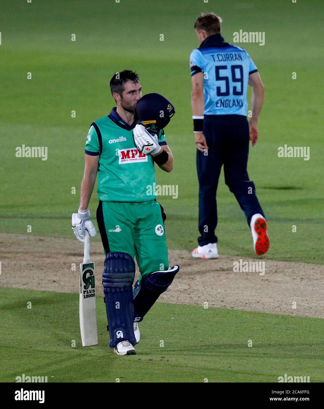 Ireland captain Andrew Balbirnie (left) kisses his helmet as he ...